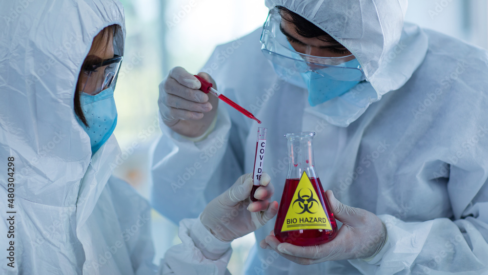 Asian male female professional scientists in ppe full protection suit ...