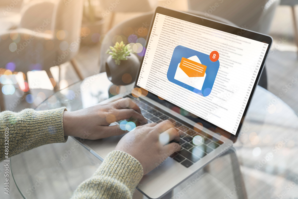 Person using a laptop computer with email communication connection ...