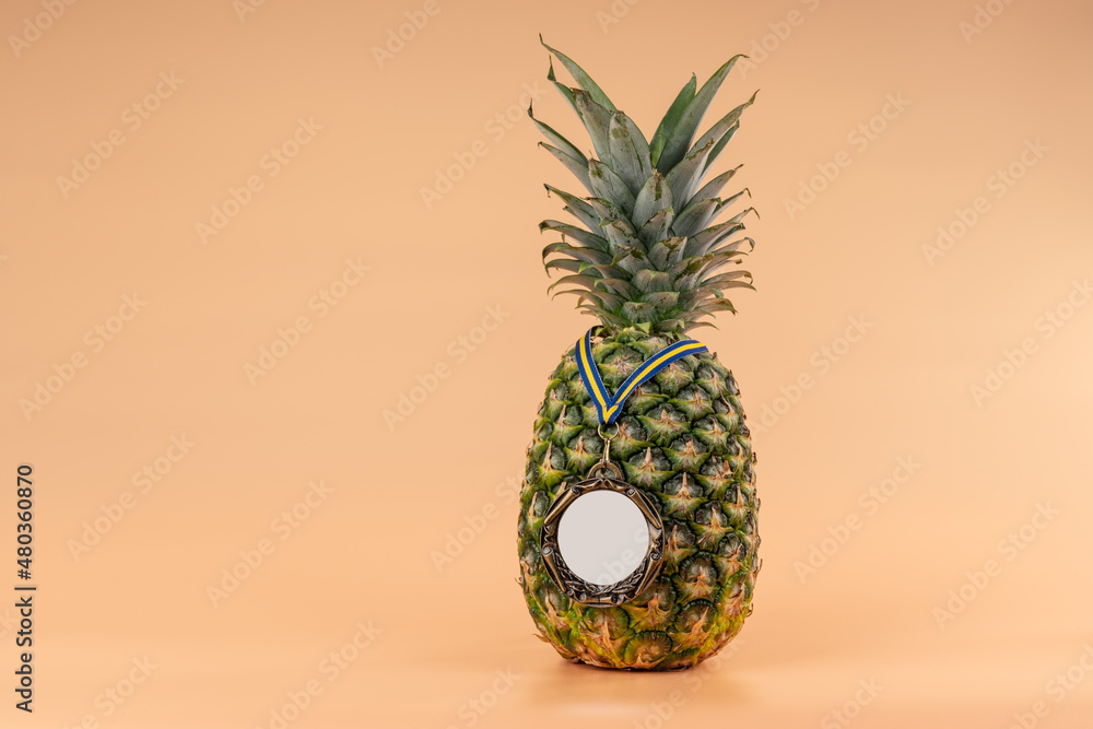 Interpretation of the pineapple fruit into a human image with a medal ...