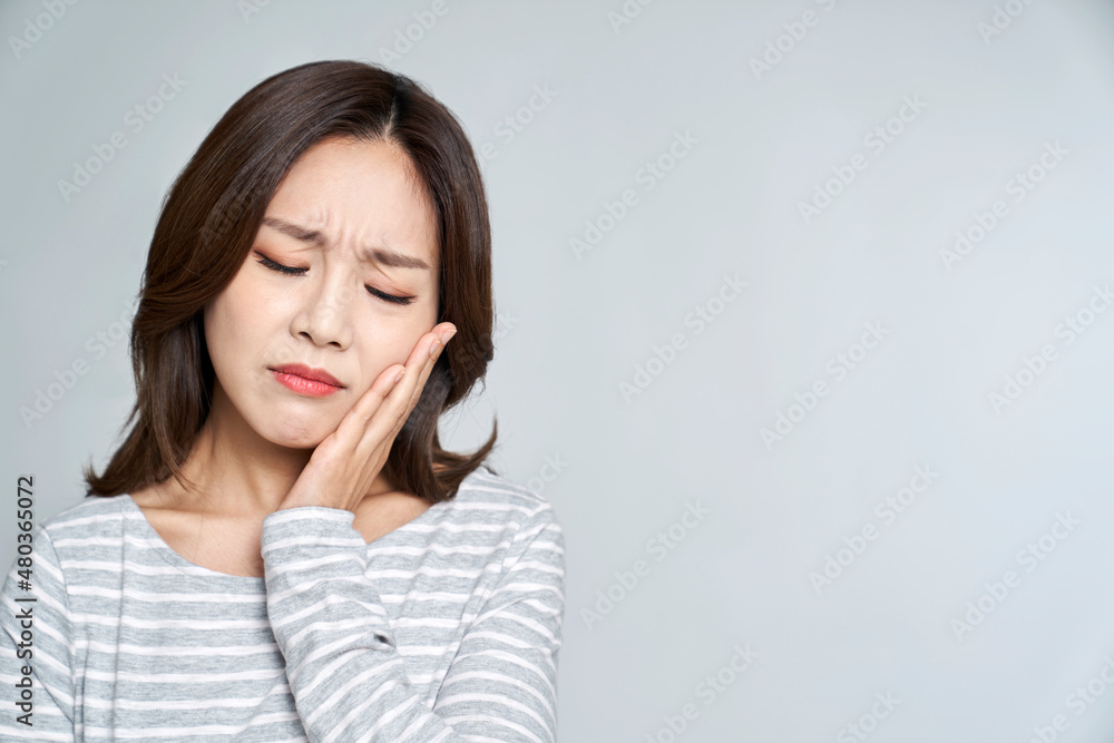 Young woman suffering from toothache with studio shot Stock Photo ...