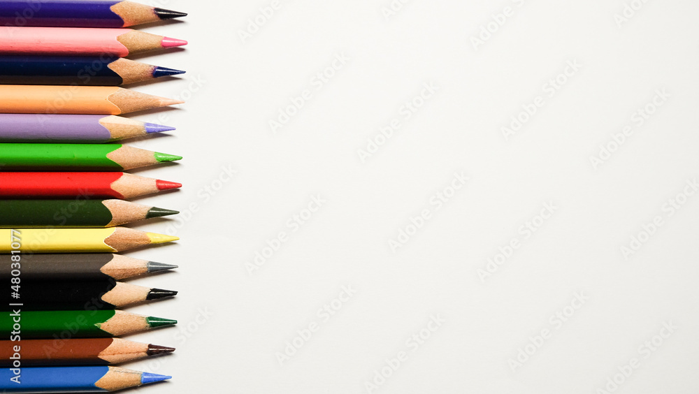 Color pencils border on white background. Isolated closeup shot with ...