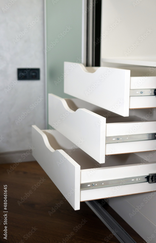 Open storage drawers in cabinet with mortise handles, modern wardrobe ...