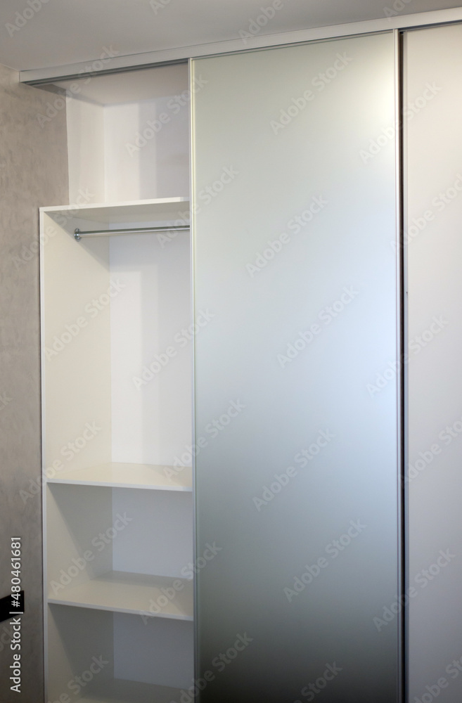 Modern wardrobe with sliding doors slide system. Shelves for storing ...