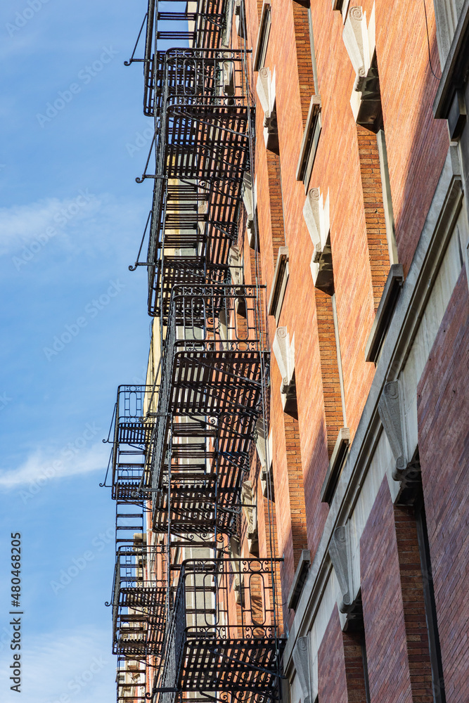 Metal fire escape on an older brick building. Stock Photo | Adobe Stock