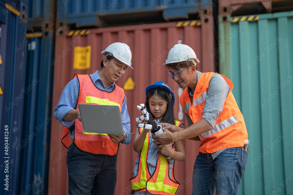 Engineer Teachers teaching a girl about robot hand In Science Robotics ...