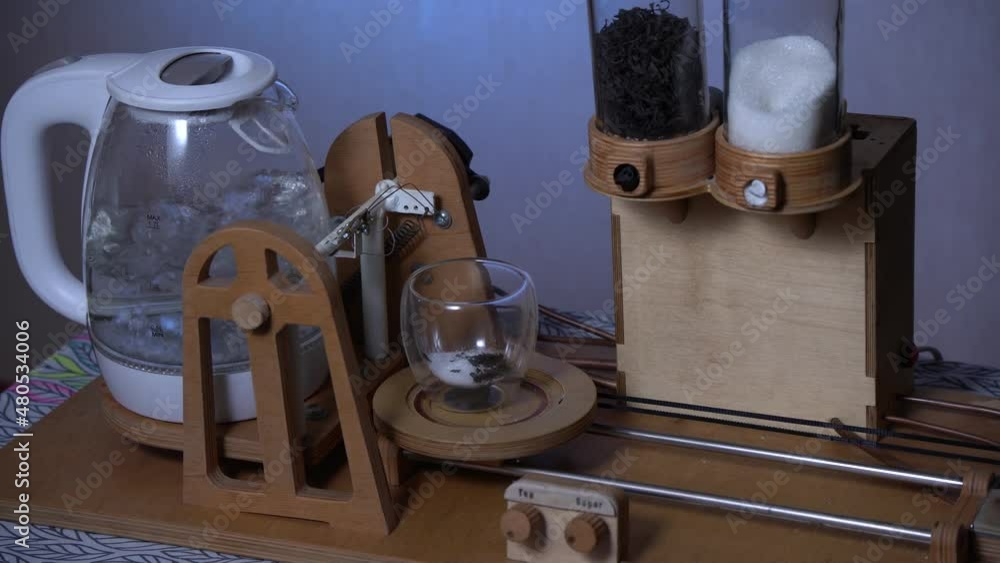 Robot for making tea. The kettle bends over and pours water into a cup ...