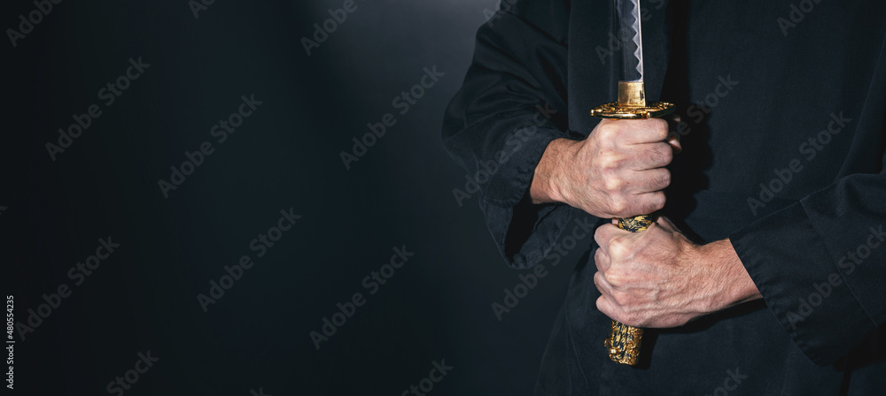 Samurai ready for battle holding a Japanese katana sword, banner. Photo ...