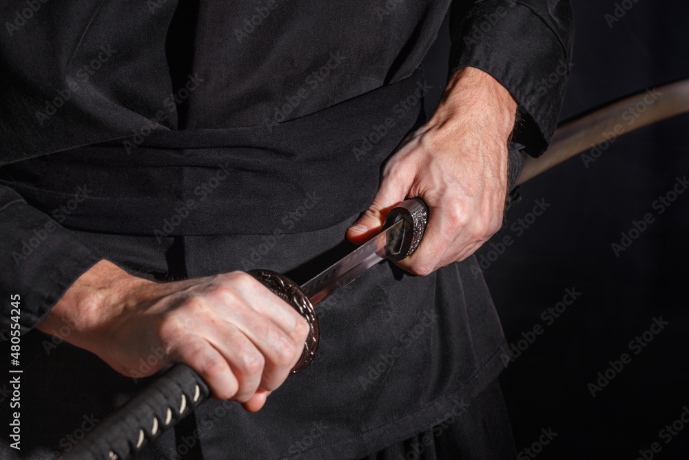 The samurai holding a Japanese katana sword. Photo of a warrior dressed ...