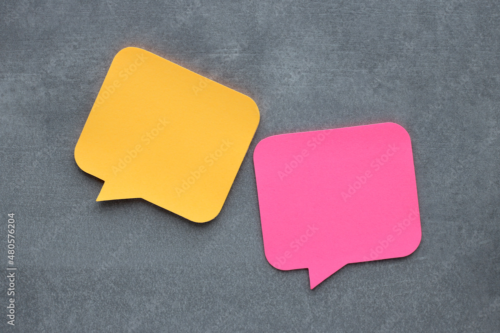 Blank square-shaped sticky notes on a gray background with multi ...