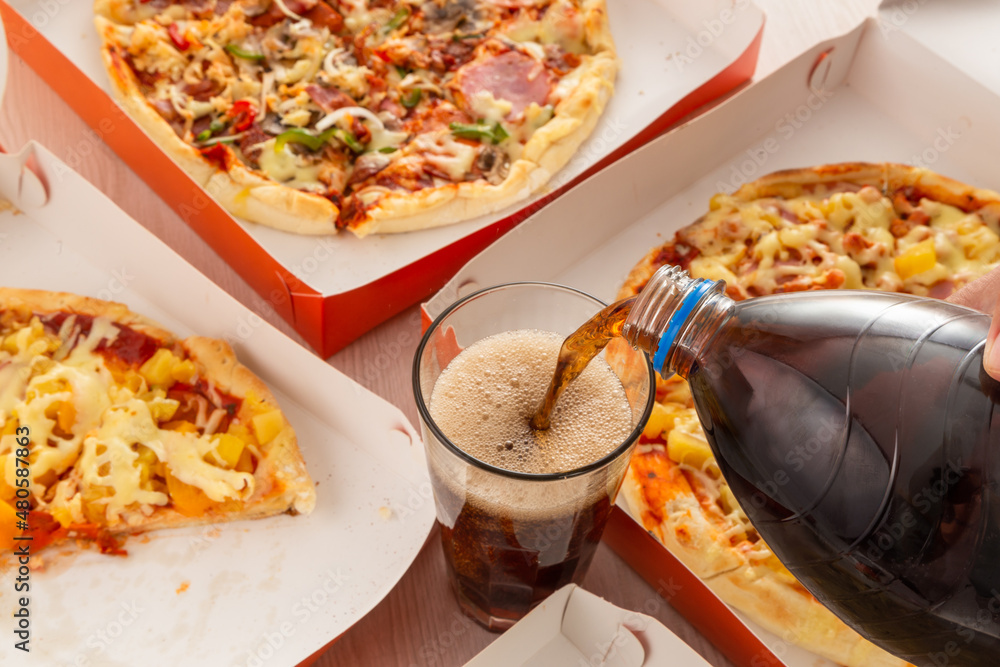 fast food served on the table, pizza with delicious ingredients and ...