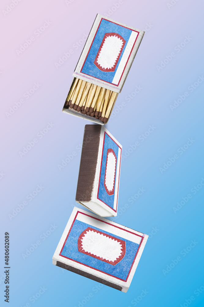 Falling open and closed matchbox on blue and pink background Stock ...