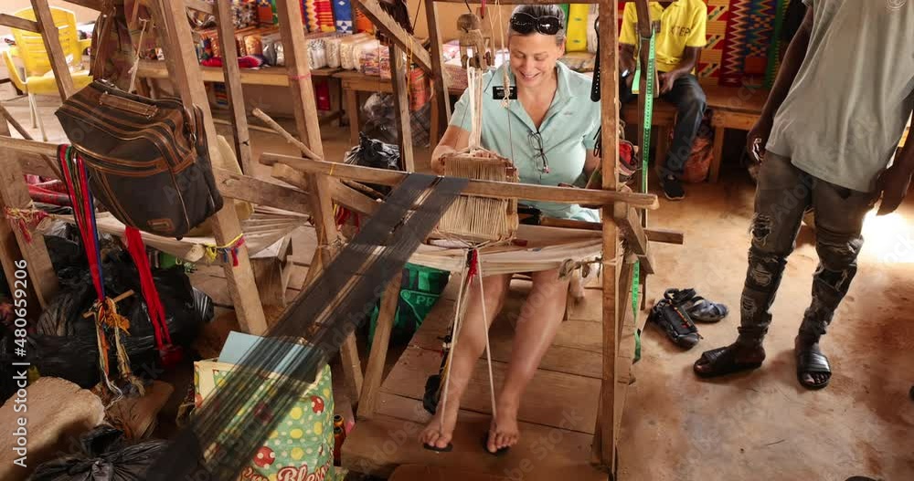 Woman tourist learning to make Kente cloth Kumasi Ghana. Traditional ...