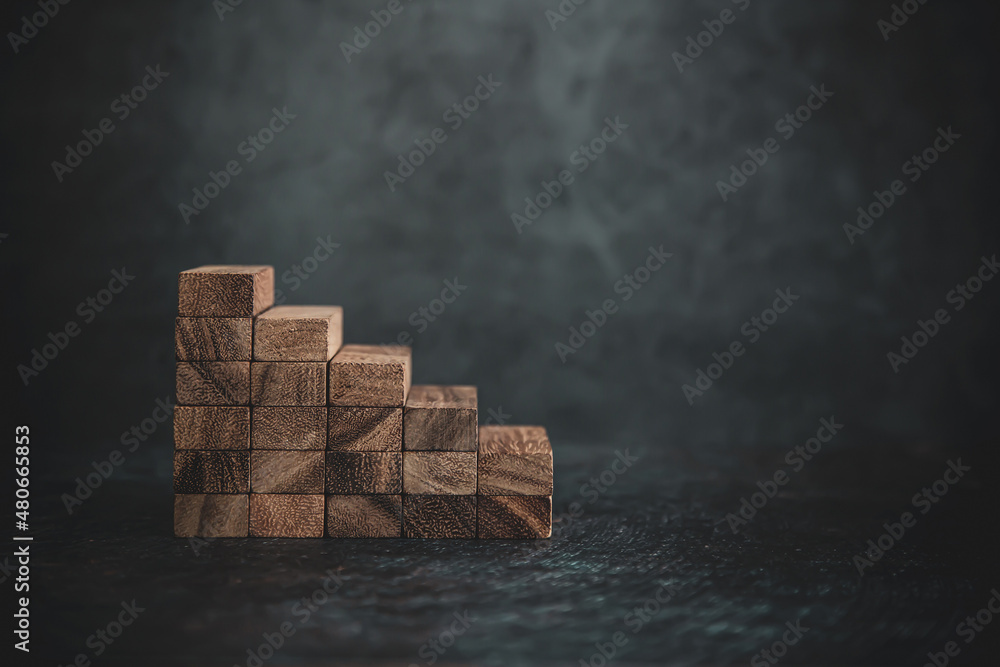 Wooden block stack in pyramid stair step concept of prevent collapse or ...