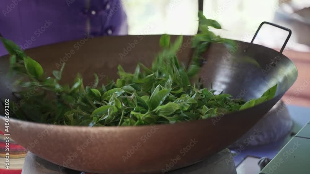 Traditional method of drying tea leaves, pan-fried tea leaves in large ...