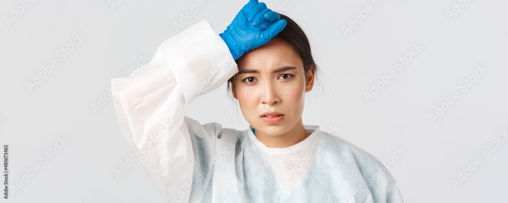 Covid-19, coronavirus disease, healthcare workers concept. Young tired ...