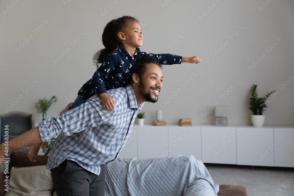 Happy African American dad piggybacking excited proud daughter kid ...
