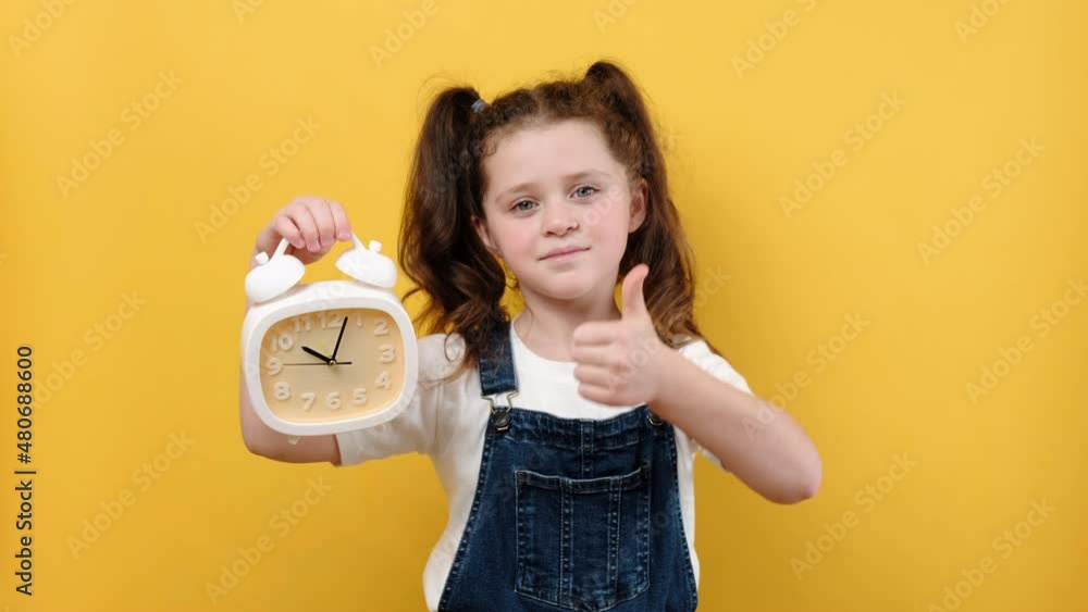 Portrait of positive cute little child girl pointing finger on big ...