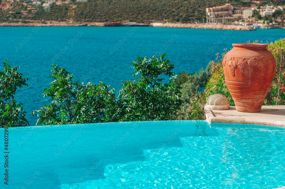 Infinity swimming pool overlooking the sea. Veranda with infinity pool ...