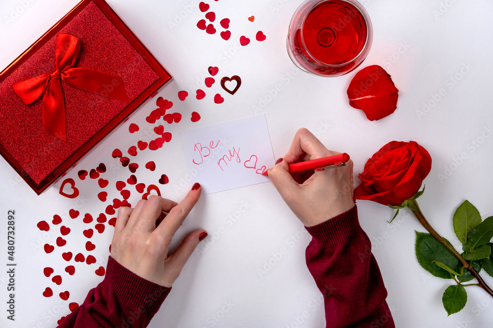 Woman writing love letter for Valentines day. Female hands write ...