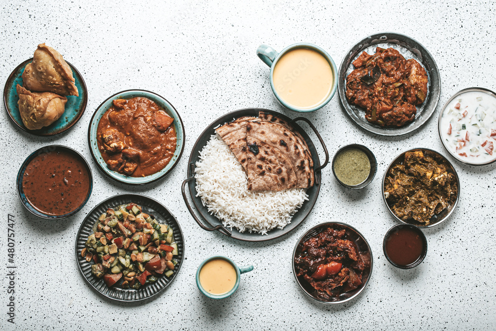 Indian ethnic food buffet on white concrete table from above: curry ...