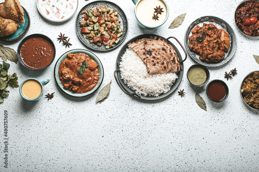 Indian ethnic food buffet on white concrete table top view: curry ...