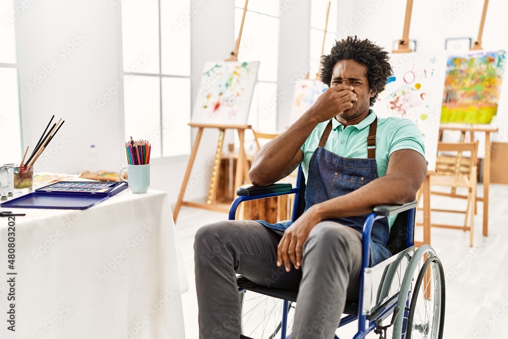 Young african american artist man sitting on wheelchair at art studio ...