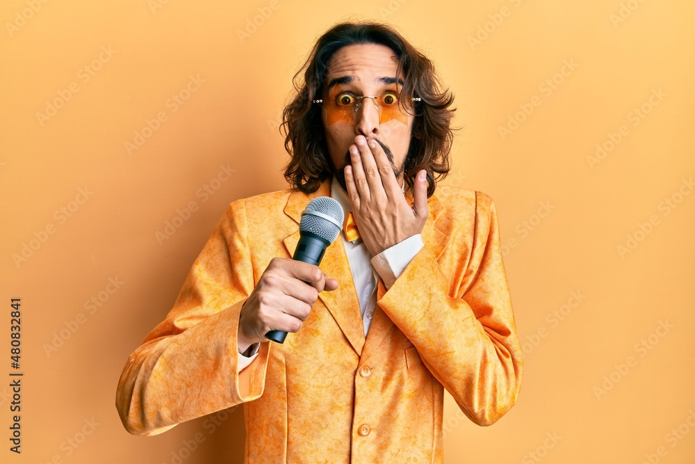 Young hispanic man wearing hipster elegant style singing song using ...