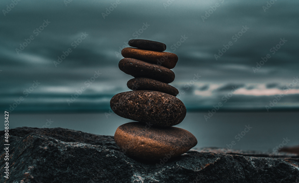 ROCK STACK IN FRONT OF DRAMATIC ENVIRONMENT Stock Photo | Adobe Stock