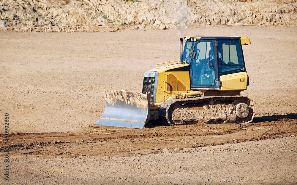 Crawler dozer with blade for leveling ground. Road construction ...