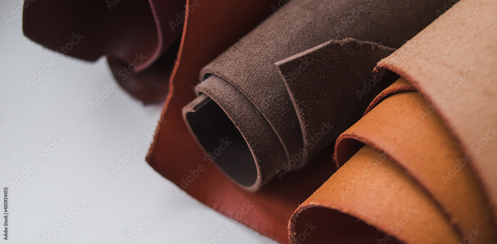 Rolls of genuine brown leather on a white background. Materials for ...