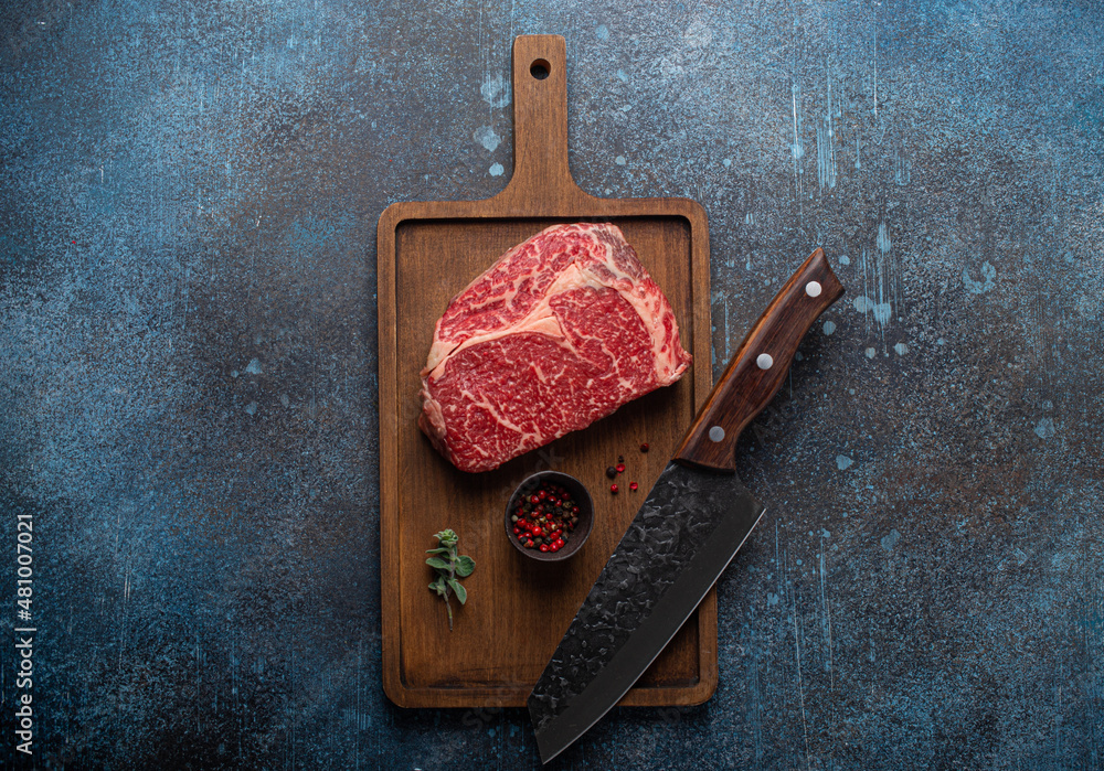 Raw meat beef marbled prime cut steak Ribeye on wooden cutting board ...