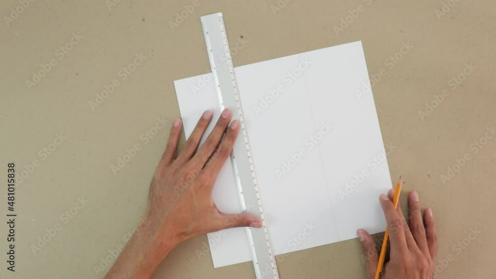 Trace a 3x3 grid on white cardboard. Craft paper background. Ruler and ...