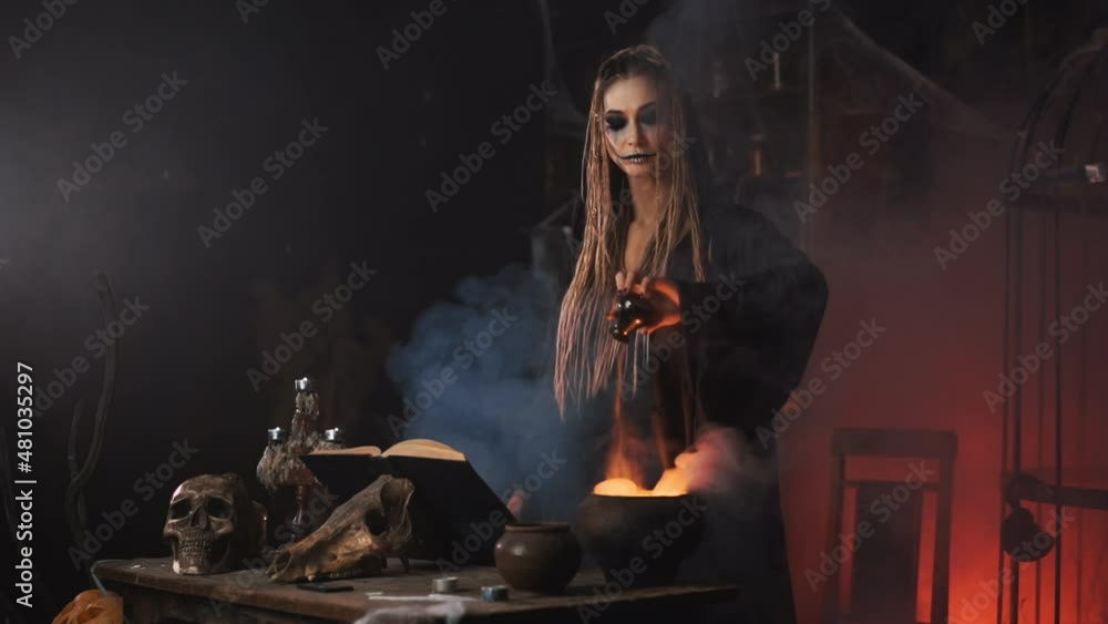 Halloween, witch use magic book and cauldron prepare poison or love ...
