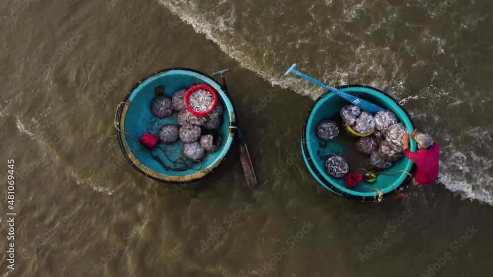 Early morning catch inside vietnamese traditional round coracle boats ...