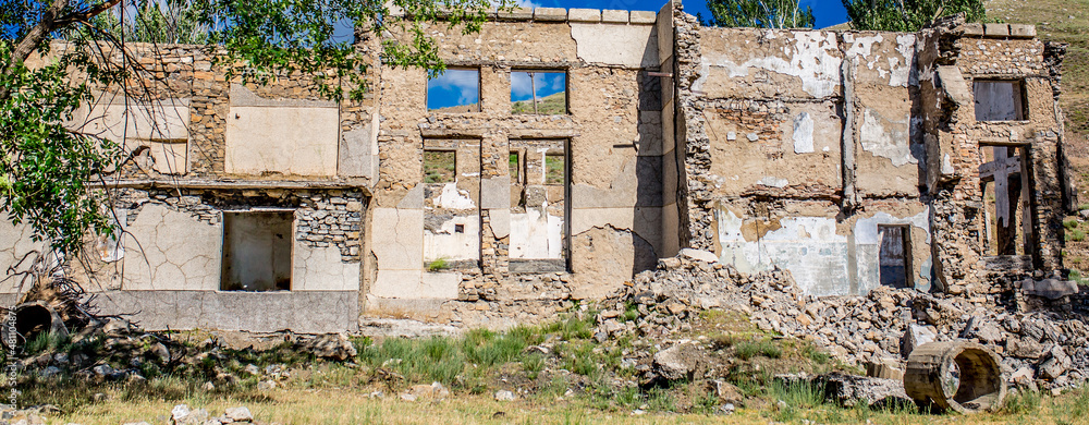 Destroyed and abandoned buildings of the city after the war, bombing or ...