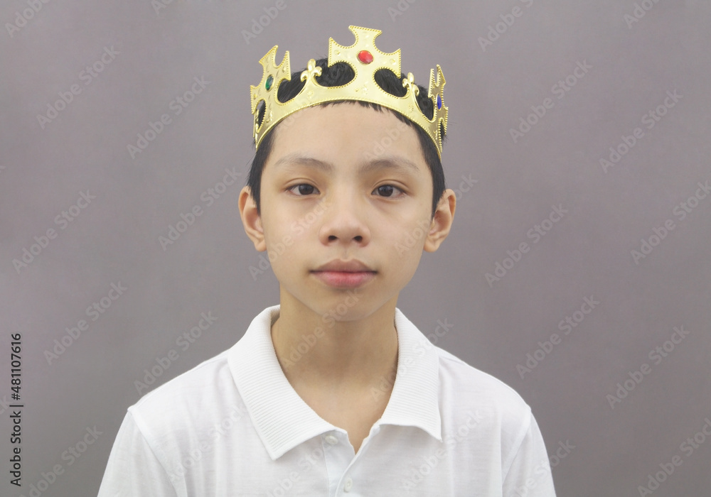 Young Asian boy with gold king crown on head close up Stock Photo ...