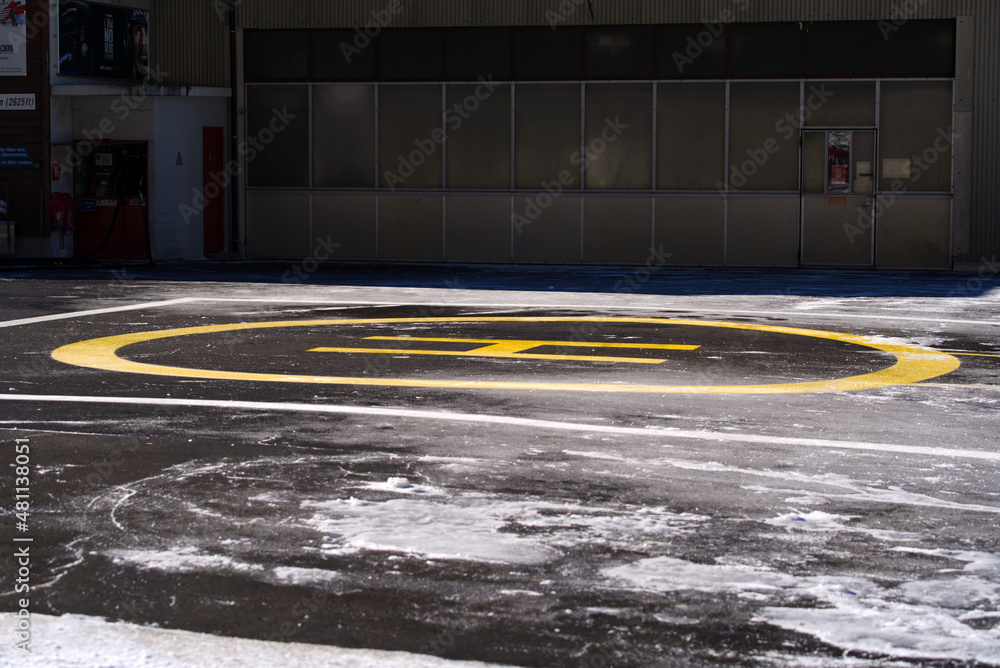 Yellow marking for helicopter landing pad at heliport at mountain ...