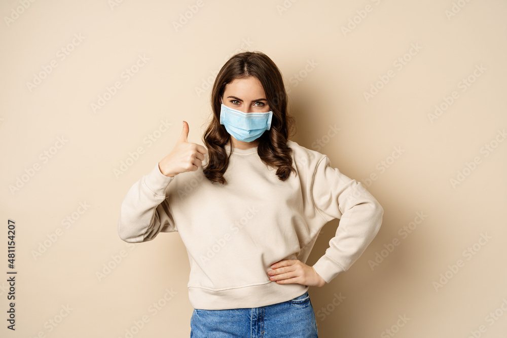 Covid-19, pandemic and quarantine concept. Young woman wears medical ...