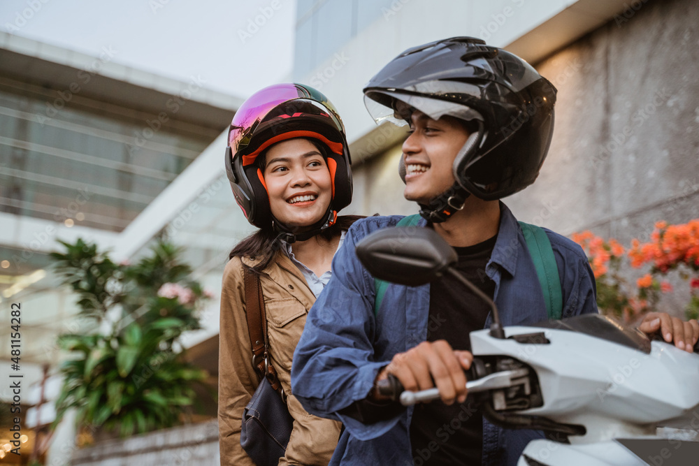 a man and woman wearing helmets riding a motorcycle Stock Photo | Adobe ...