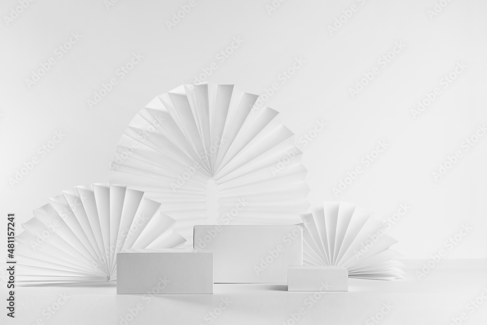 Bright white abstract stage with three different rectangle stands ...