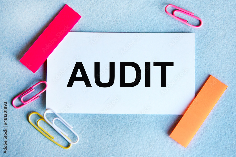 On the business card is the text audit, next to the color clips and ...