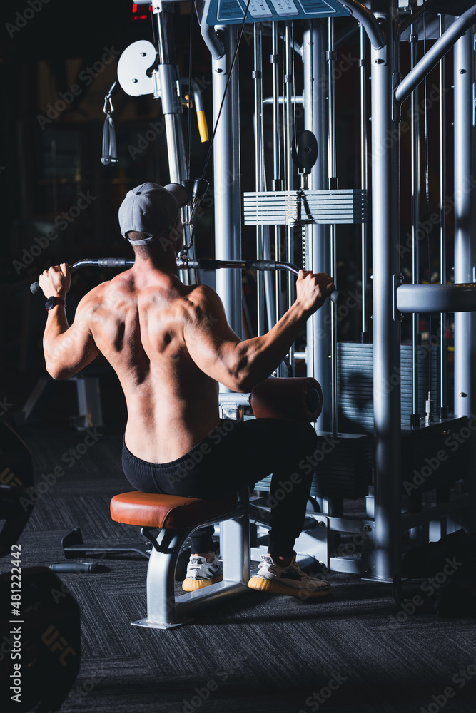 Fitness white ethnicity man working out in gym doing exercise focusing ...