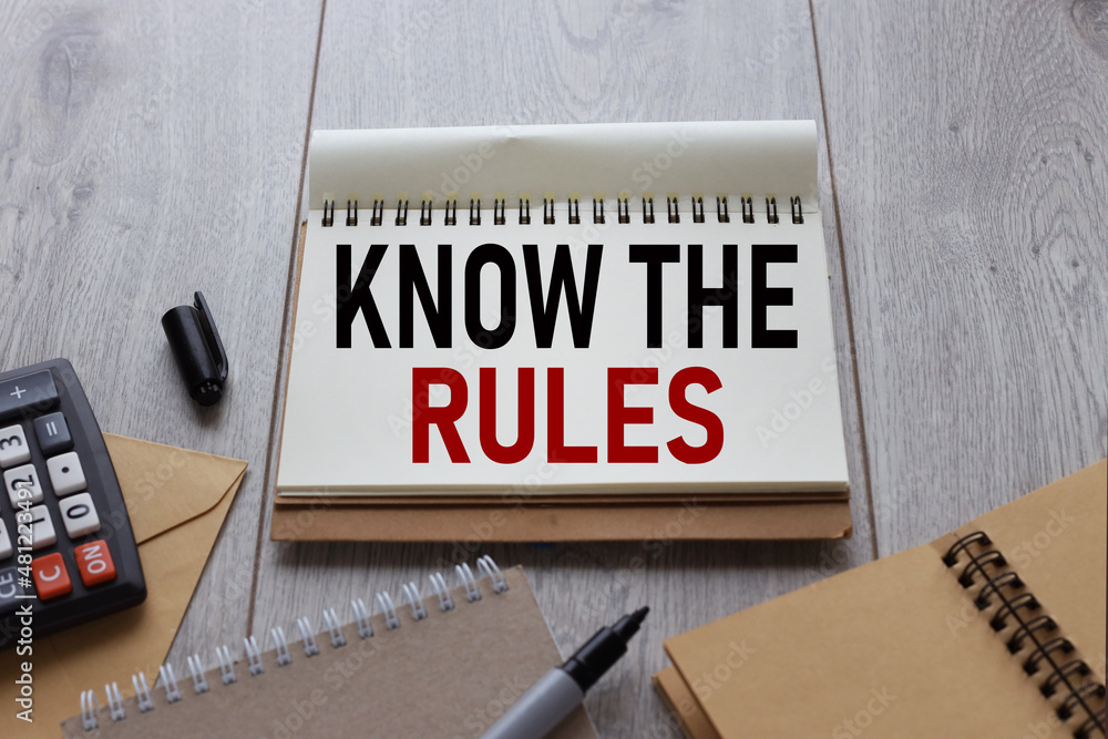 KNOW THE RULES, open notebook with a spring and a calculator on a ...
