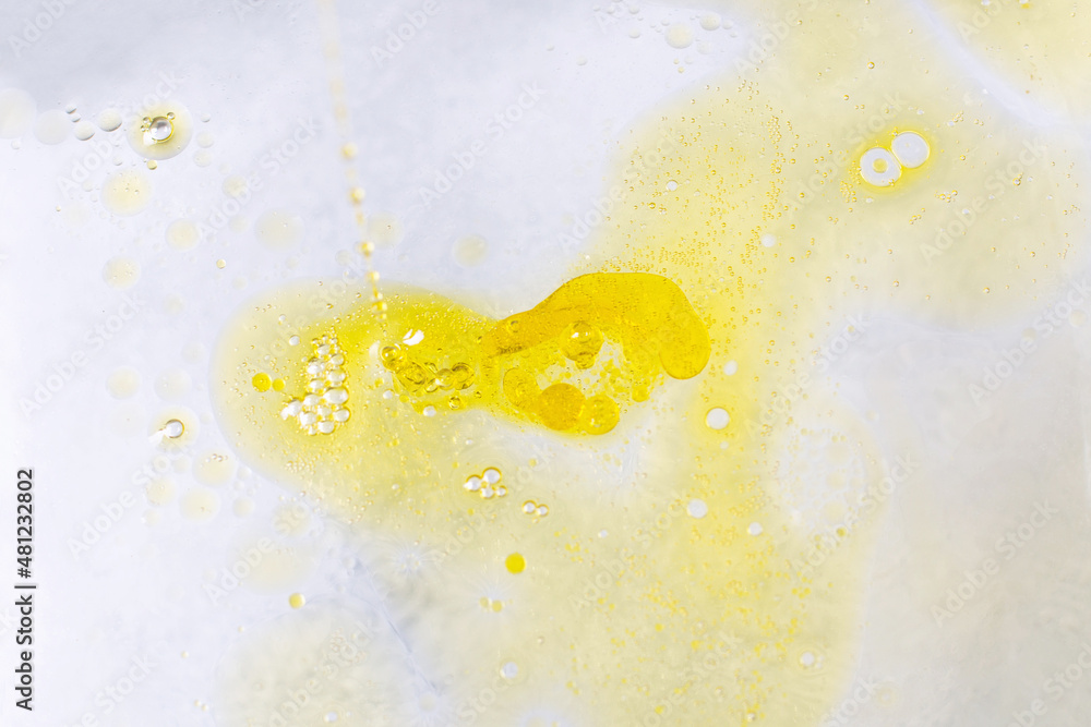 Texture and droplets of yellow oil. The texture of the oil is close-up ...