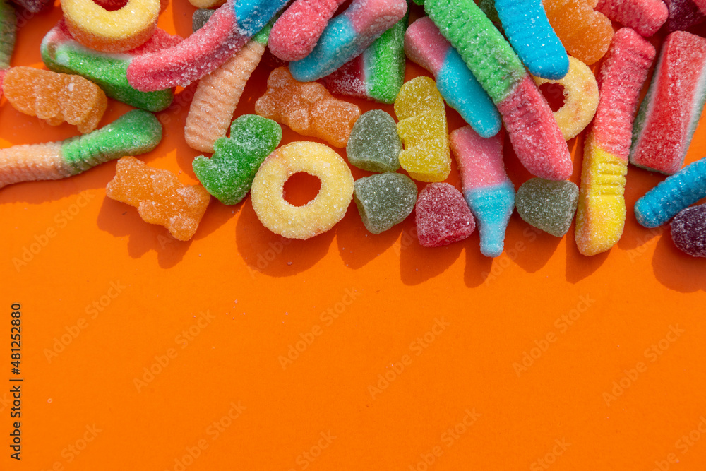 Fizzy candy against an orange background Stock Photo | Adobe Stock