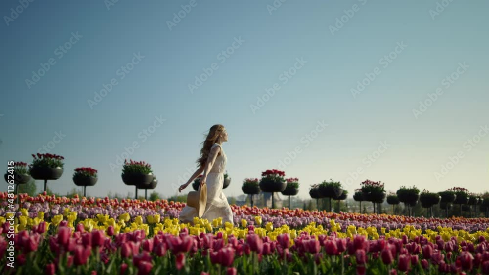 Young woman relaxing in summer flower garden. Girl feeling free ...
