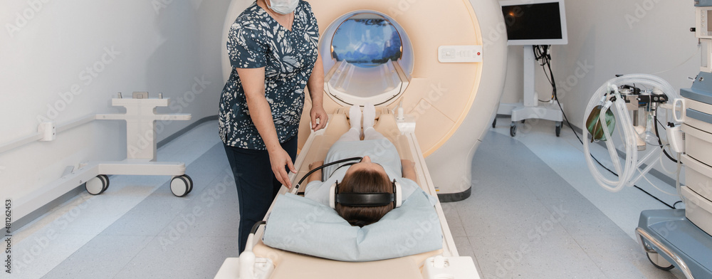 Doctor or nurse and patient with tomography CT or MRI Scan in hospital ...