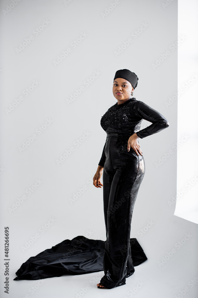 Alluring african islamic woman wearing elegant black clothes and hat ...