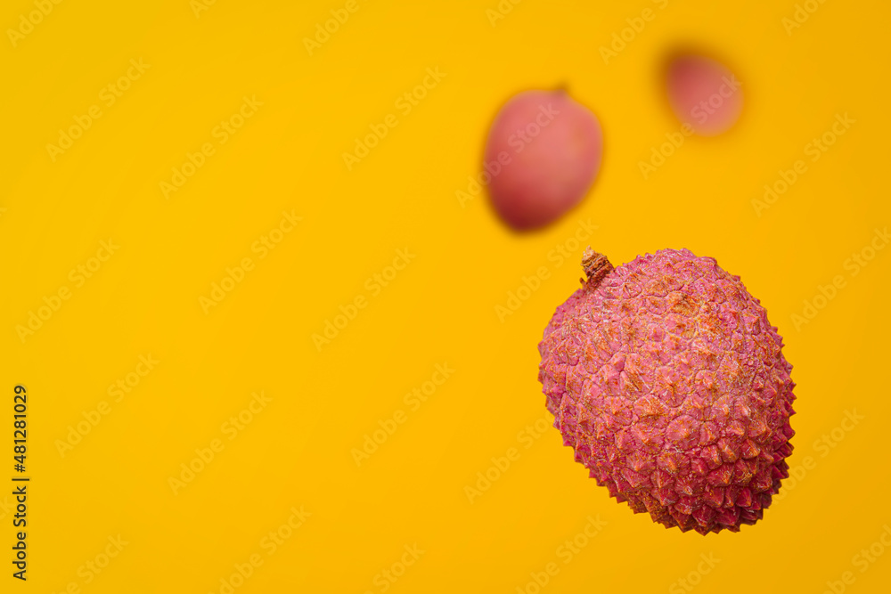 Litchi on isolated yellow background. Minimal fruits display of lychees ...