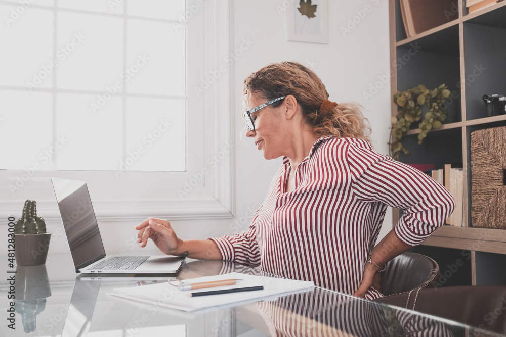Caucasian woman touching her back for stress pain and disease caused by ...